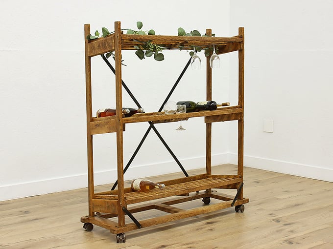 A rustic rolling rack that proves even wine storage can have serious old-world charm.