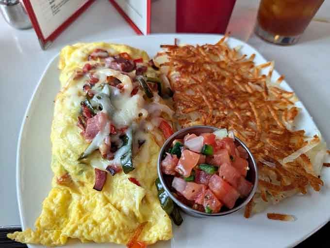 That omelet is stuffed with more goodness than your grandmother's attic, and those hash browns are golden perfection.