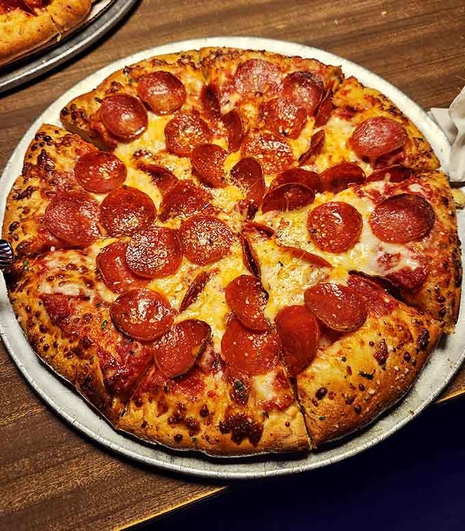 Behold the pepperoni pizza in its natural habitat, glistening with grease and absolutely zero regrets about carb counts.