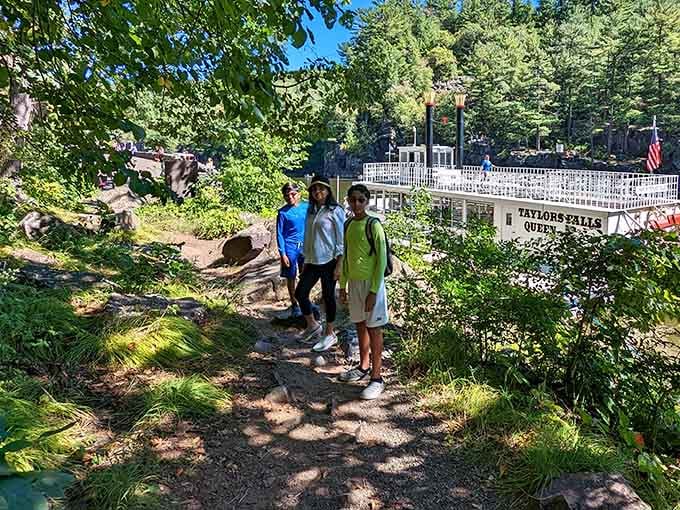 Hikers pause near the scenic boat tour, because sometimes walking and floating both have their merits.