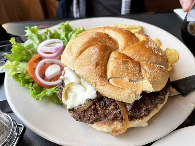 Behold the burger that launched a thousand return visits, topped with caramelized onions and enough cheese to make you swoon.