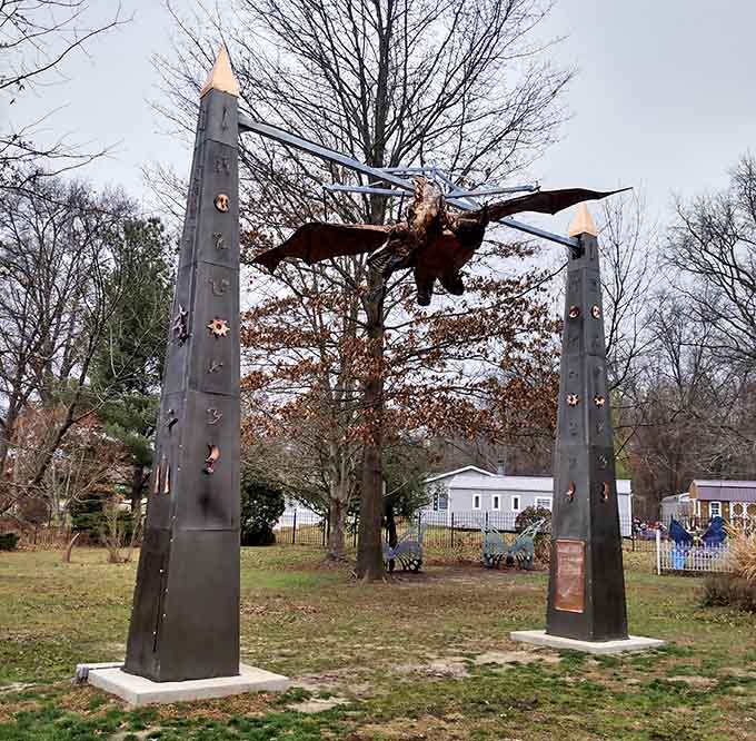 Soaring between towers, this dragon guards the kingdom with wings spread wide, forever frozen in majestic flight above the playground.