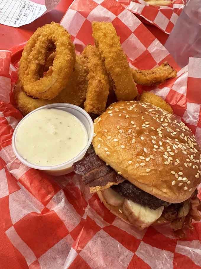 The Elvis Burger arrives on a sesame seed bun looking like it just won the lottery of deliciousness.