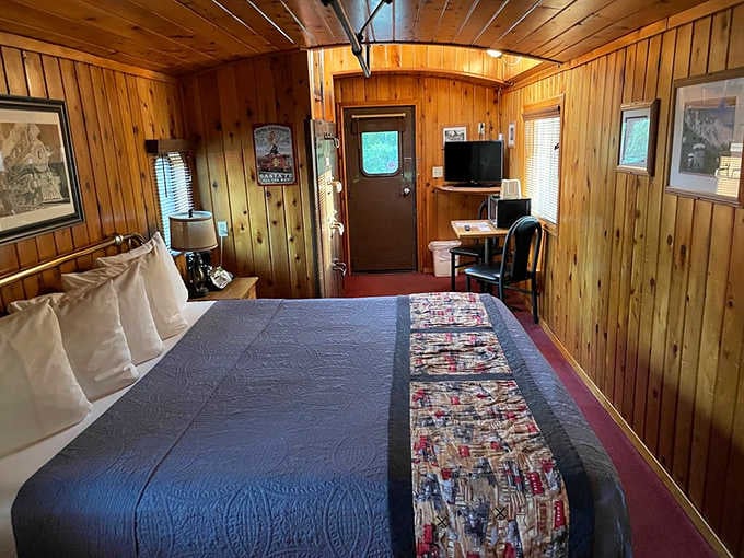 The Red Cupola Caboose offers cozy wooden interiors where railroad history meets surprisingly comfortable modern sleep.