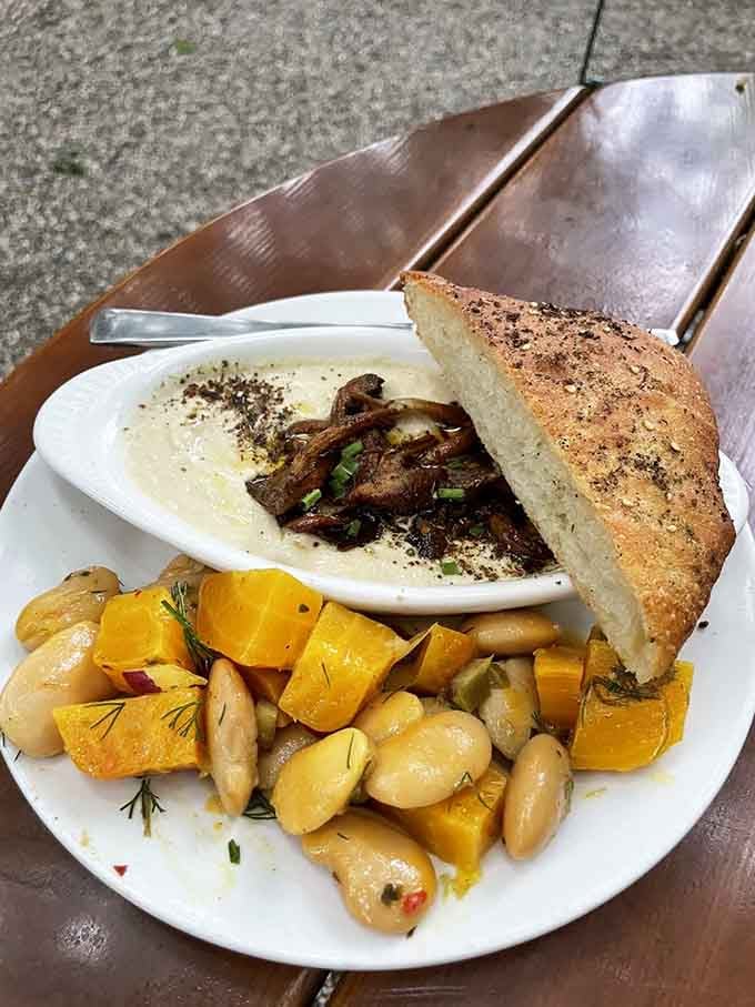 Creamy hummus with roasted mushrooms and crusty bread proves that simple ingredients can create absolute magic on a plate.