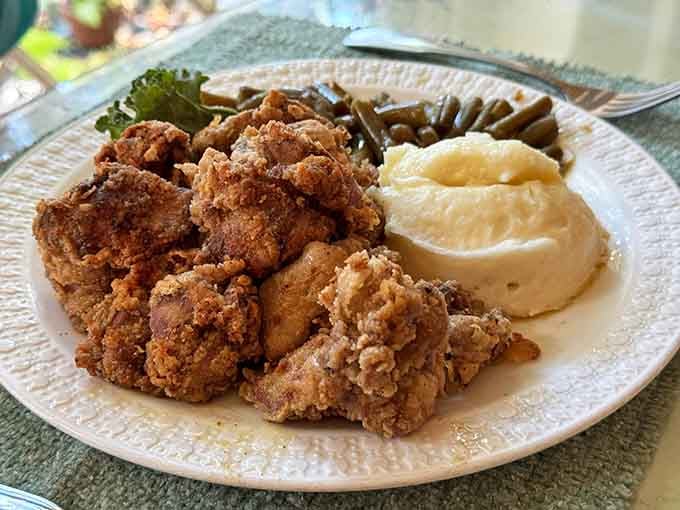 Golden fried chicken so perfectly crispy it could make a vegetarian reconsider their entire life philosophy momentarily.