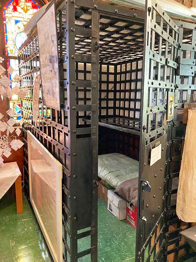 Yes, that's an actual jail cell in a former church, because nothing says "redemption" quite like literal bars.
