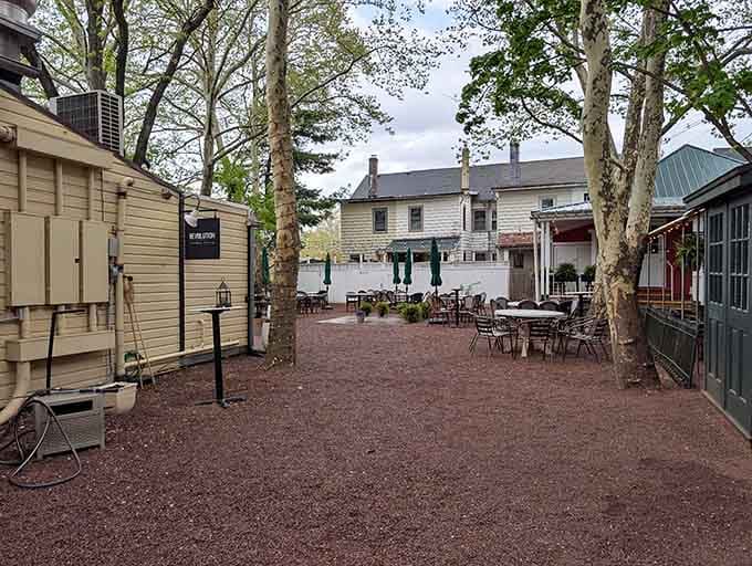 This charming courtyard dining area proves that sometimes the best meals happen under actual trees instead of fluorescent lights.