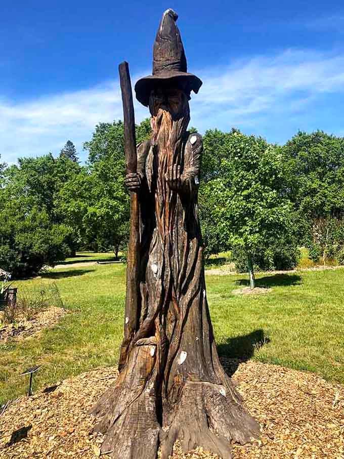 Merlin would absolutely approve of this wizard carving, staff and all, standing guard over the gardens like magic is real.