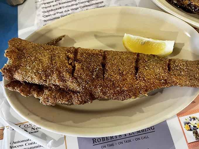Behold the golden standard by which all other fried catfish should be measured, crispy perfection on a plate.