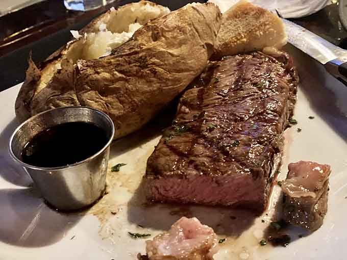 That perfect medium-rare New York strip with a baked potato the size of a small football is pure steakhouse poetry.