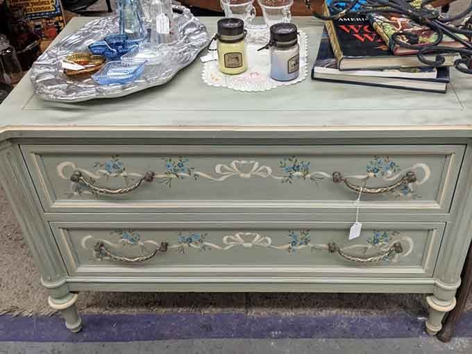 Hand-painted floral details on vintage furniture prove that people once cared deeply about making dressers look absolutely spectacular.