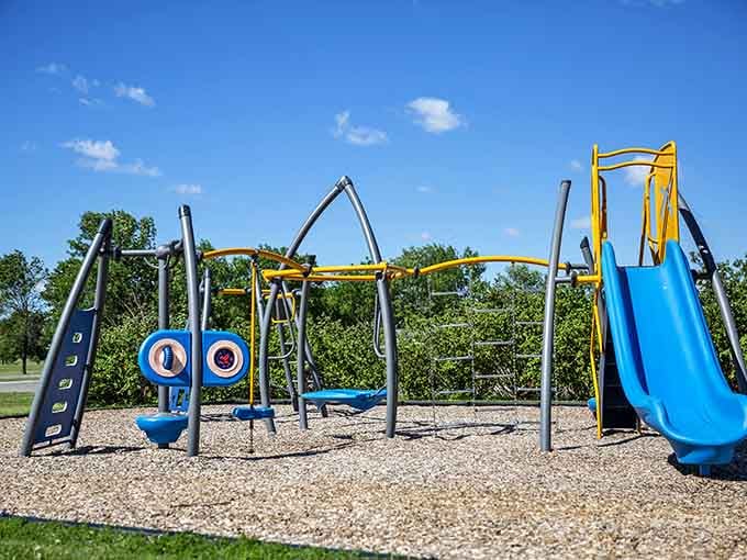 Playground equipment stands ready for families who can actually afford to have fun after paying rent.