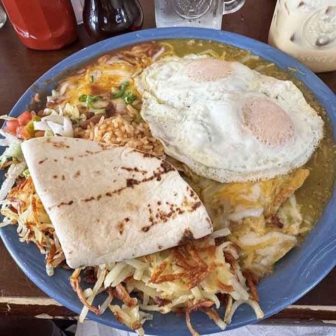 Behold the chilaquiles in all their glory: crispy chips, perfectly cooked eggs, and sides that complete the masterpiece.