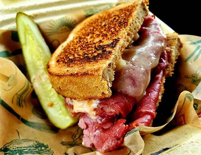 Behold the Reuben in all its glory, piled high with corned beef and grilled to crispy, melty, absolutely no-regrets perfection.