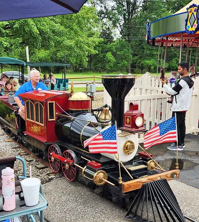 This miniature locomotive with its gleaming brass bell looks like it chugged straight out of a Norman Rockwell painting.