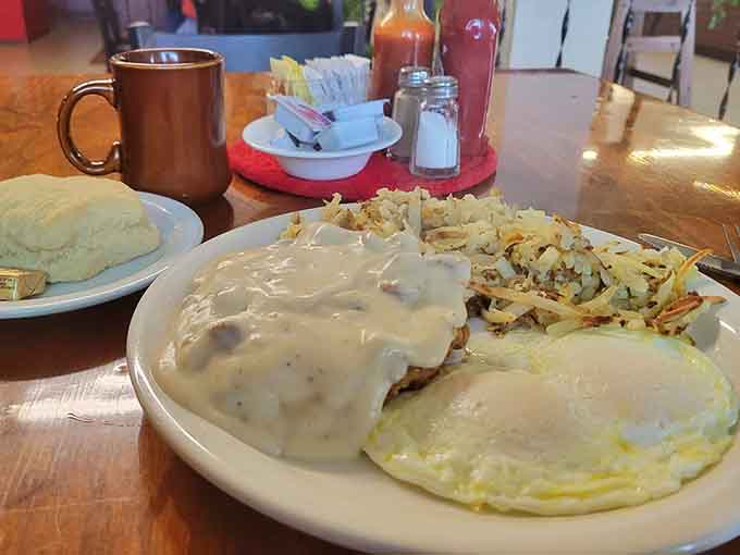 Country fried steak drowning in gravy with hash browns that could convert a salad enthusiast permanently.