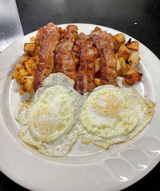 Those perfectly cooked eggs and crispy bacon strips arranged like soldiers prove breakfast is serious business here.