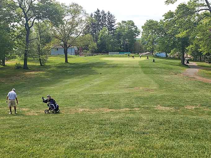 Rolling fairways stretch beneath open skies where your biggest worry is reading the green, not your retirement account balance.