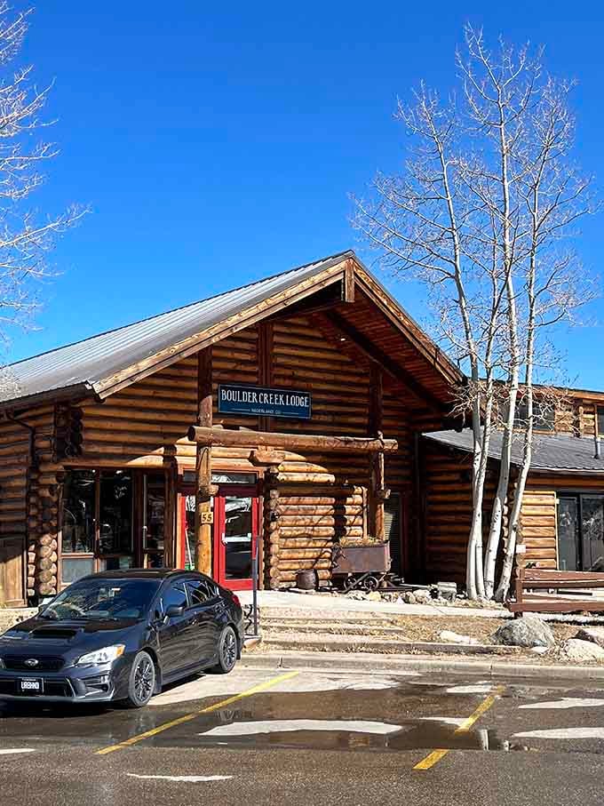 Boulder Creek Lodge's log cabin exterior promises cozy mountain vibes and that authentic Colorado experience you're craving.