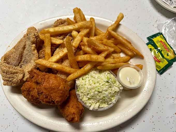 Golden catfish, crispy fries, and creamy slaw: the holy trinity of Southern comfort on one glorious plate.