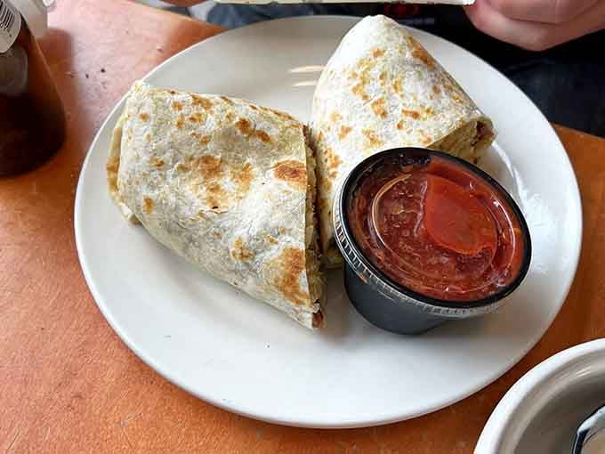 The breakfast burrito arrives like a warm, delicious hug wrapped in a tortilla—comfort food at its absolute finest.