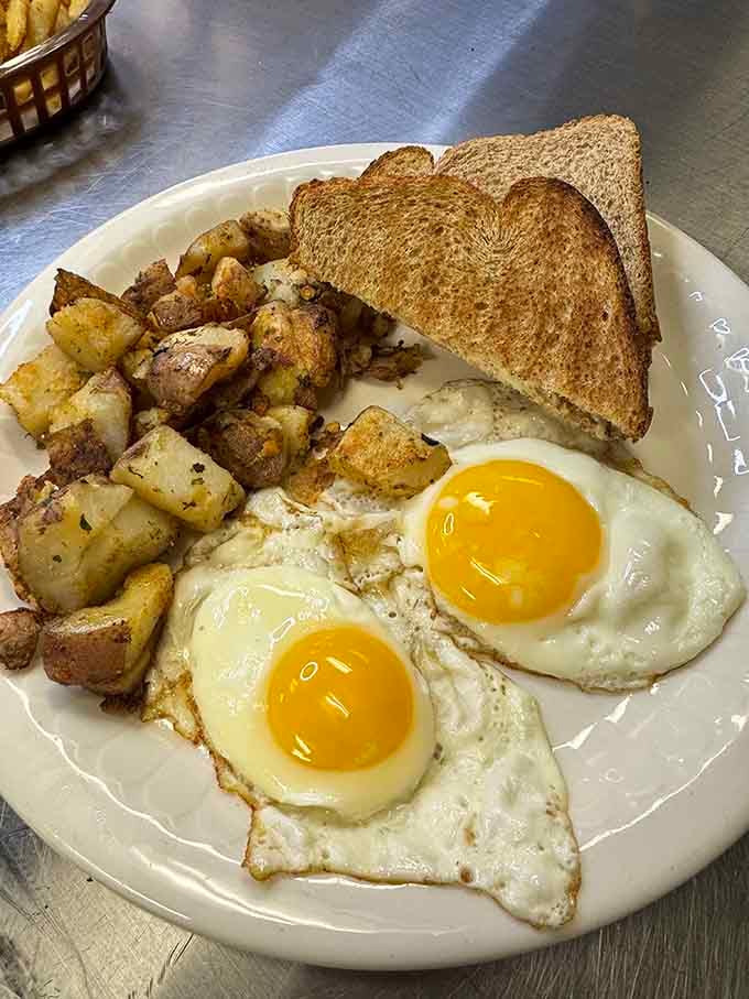 Two perfectly cooked eggs and golden home fries that look like they were made by someone's very talented grandmother.