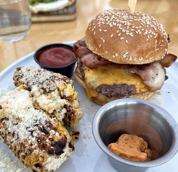 That sesame seed bun is cradling bacon, beef, and melted cheese like it's protecting the Crown Jewels of burgerdom.
