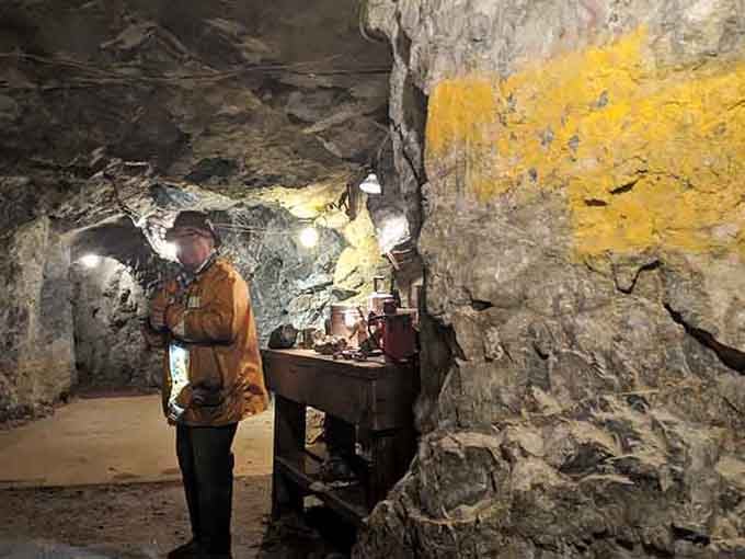 Original mining equipment still sits exactly where it was last used, like a time capsule nobody bothered closing.