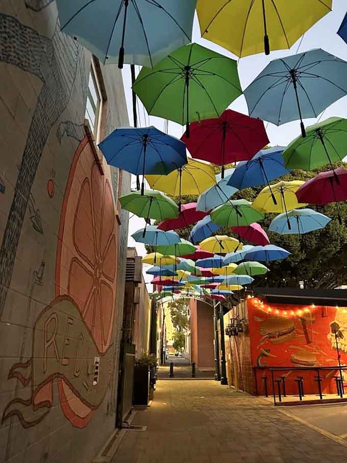 Street art meets sky art in this delightful collision of color, creativity, and pure whimsy overhead.