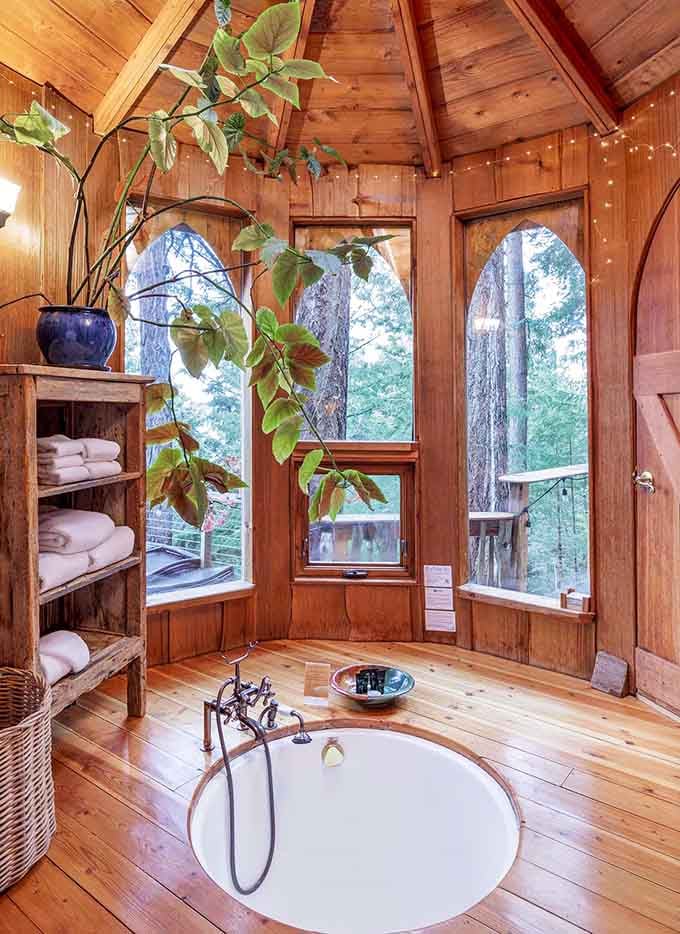 A soaking tub surrounded by forest views and warm wood paneling, because even fairytale characters deserve proper spa days.