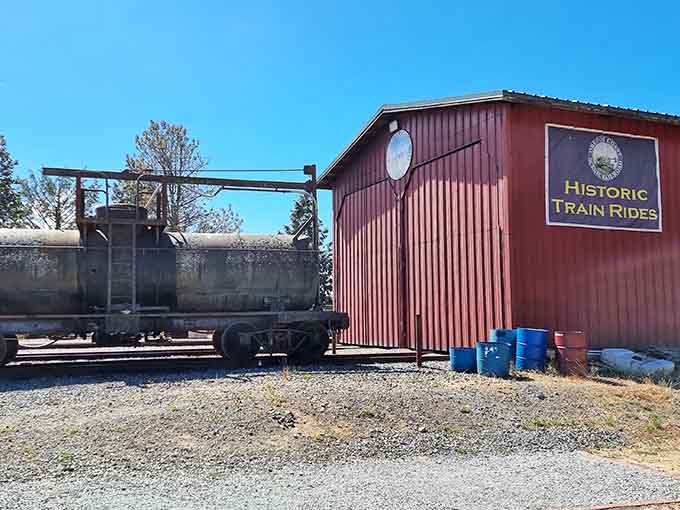The red "Historic Train Rides" building stands ready to house these magnificent machines between their scenic coastal journeys.