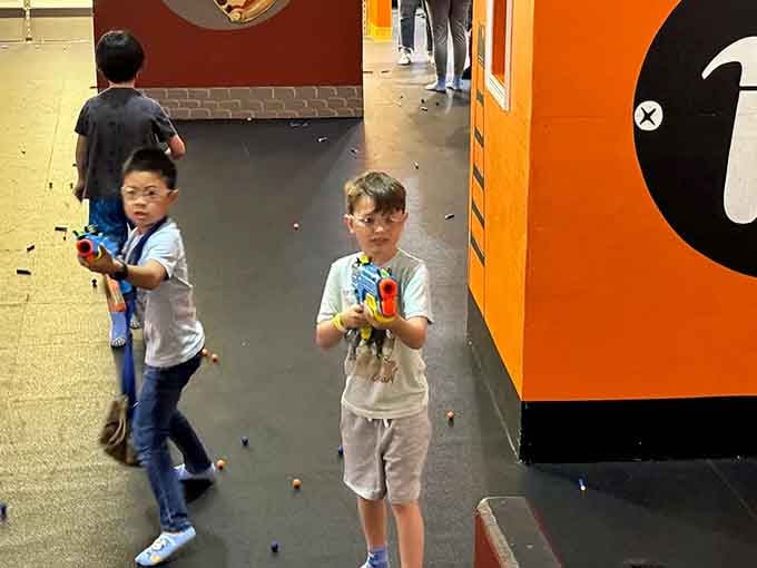 Young warriors grip their weapons with the seriousness of action heroes, ready to defend their honor one foam dart at a time.