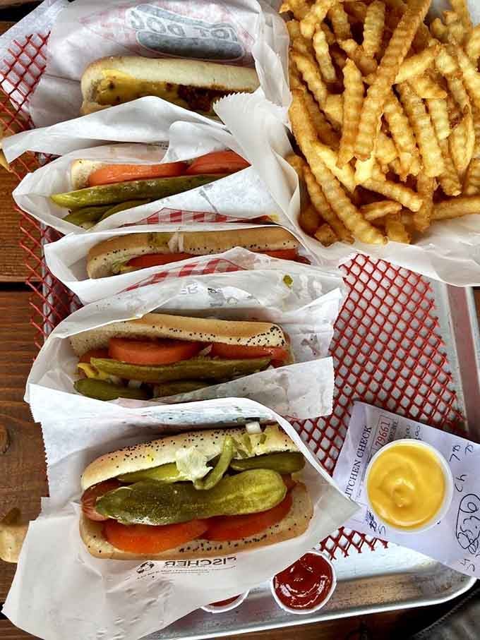 Chicago-style dogs lined up like soldiers ready for duty, complete with those neon green sport peppers demanding respect.