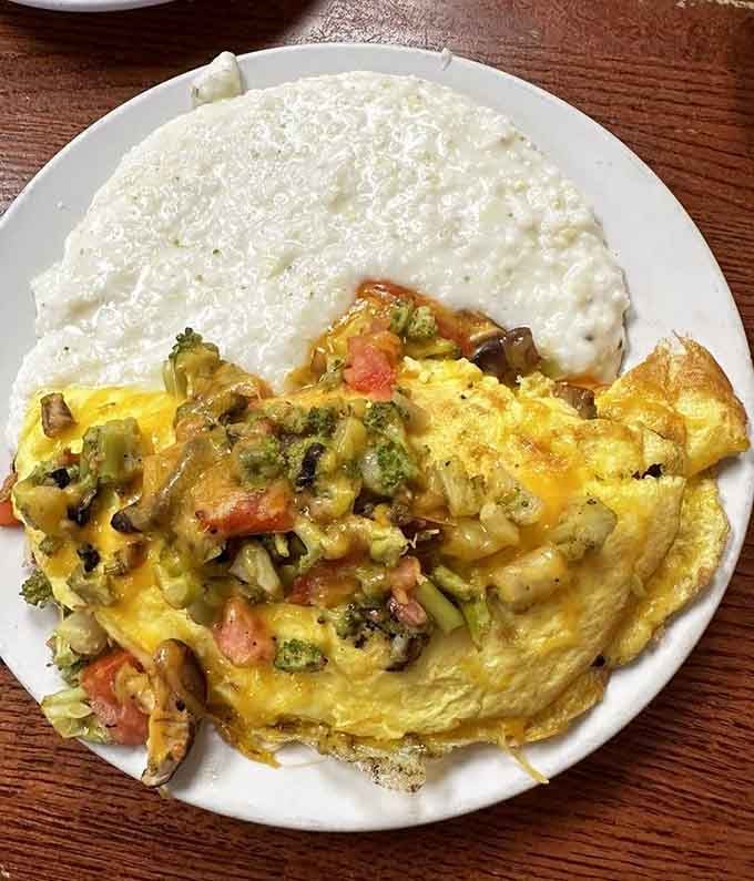 That veggie omelette looks like a garden decided to throw a party and invited melted cheese.