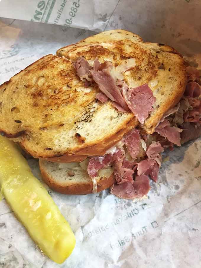 Golden-griddled rye bread barely contains the corned beef avalanche, with that pickle providing moral support on the side.