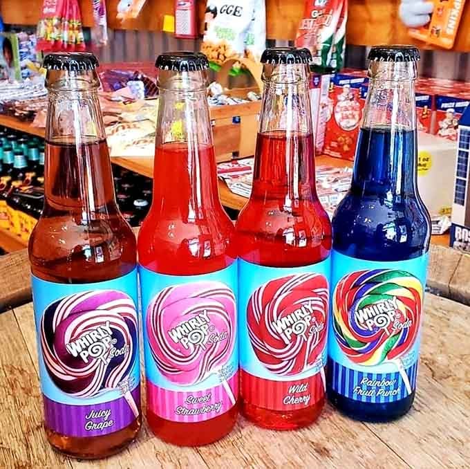 Whirly Pop sodas line up like liquid rainbows, each bottle promising a different fruity adventure.