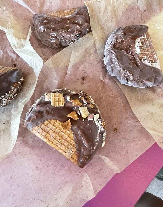 Chocolate-dipped waffle tacos lined up like edible works of art, proving dessert can be both beautiful and delicious.
