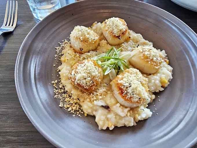 Perfectly seared scallops nestled in risotto prove that simple elegance never goes out of style, especially lakeside.