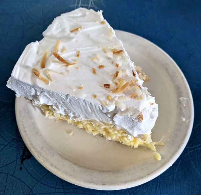 Coconut cream pie piled high with whipped cream, because sometimes more is actually more, not less.