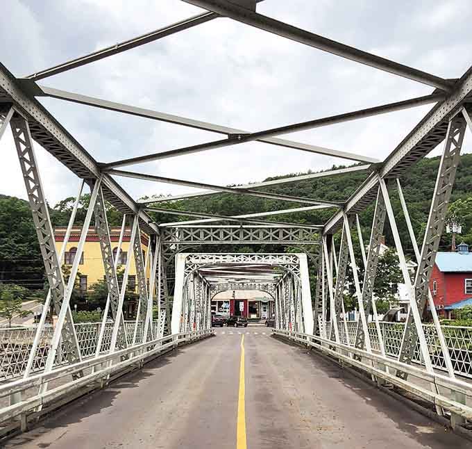 The Iron Bridge's geometric perfection framing colorful buildings&mdash;engineering meets postcard, and both win spectacularly.
