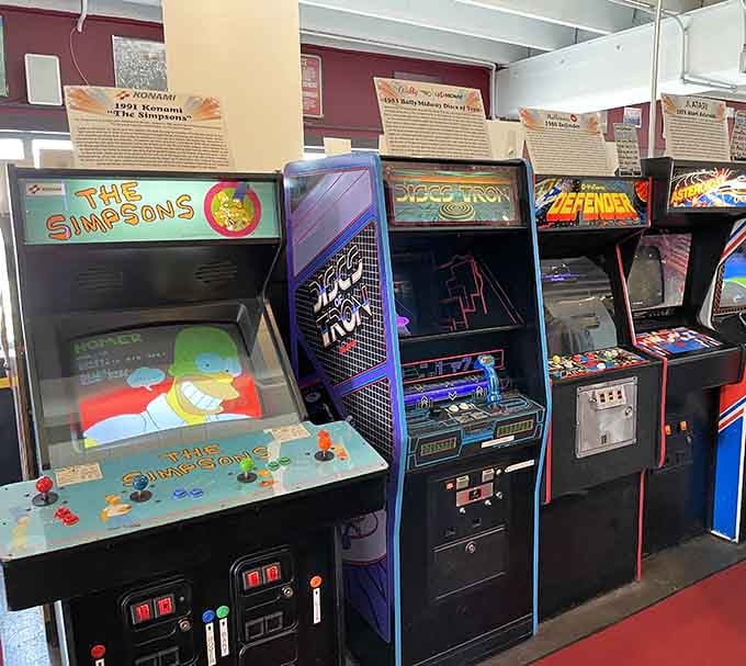 The Simpsons arcade cabinet sits alongside classics, proving Springfield's first family conquered every entertainment medium they touched.