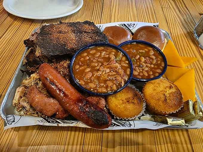 Behold the Ultimate Platter: ribs, brisket, sausage, and enough sides to require strategic planning before diving in.