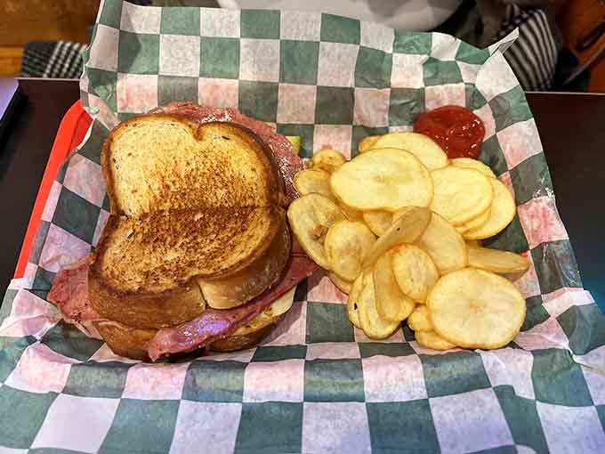 The Reuben arrives on perfectly grilled bread with chips, ready to make your taste buds sing show tunes.