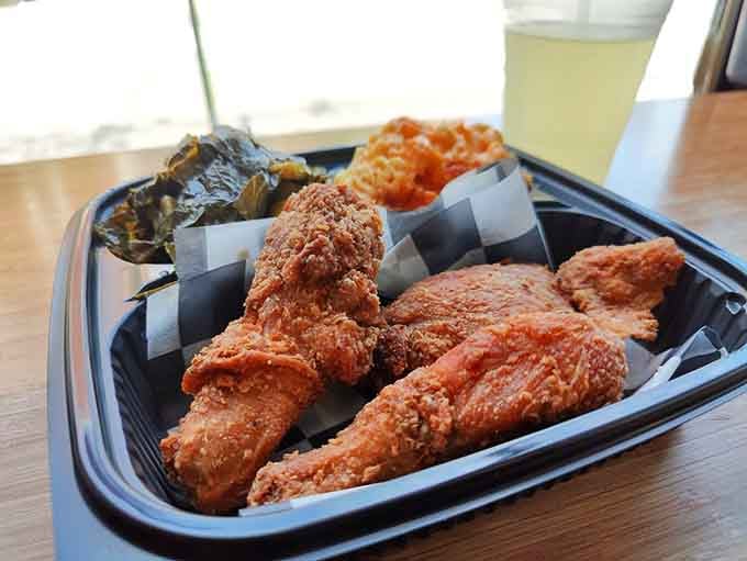Golden fried chicken with collard greens and mac and cheese: the holy trinity of soul food done absolutely right.