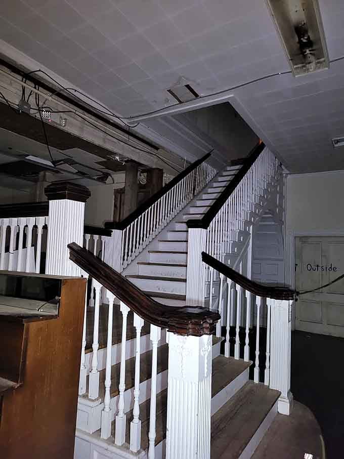 This grand staircase once echoed with footsteps; now it just echoes with your rapidly beating heart.