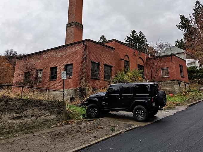 That old boiler building and towering smokestack remind you this place once hummed with life, not just eerie silence.