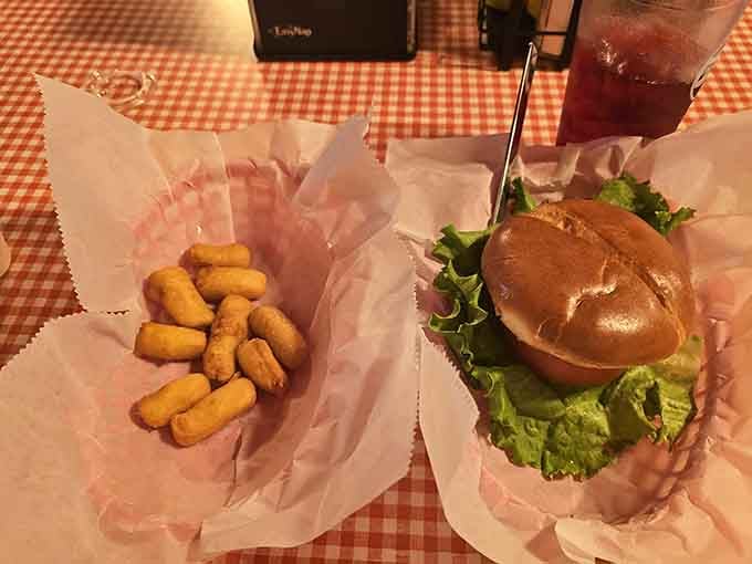 Golden tater tots and a proper burger, served in wax paper like comfort food should be. No pretense, just delicious.