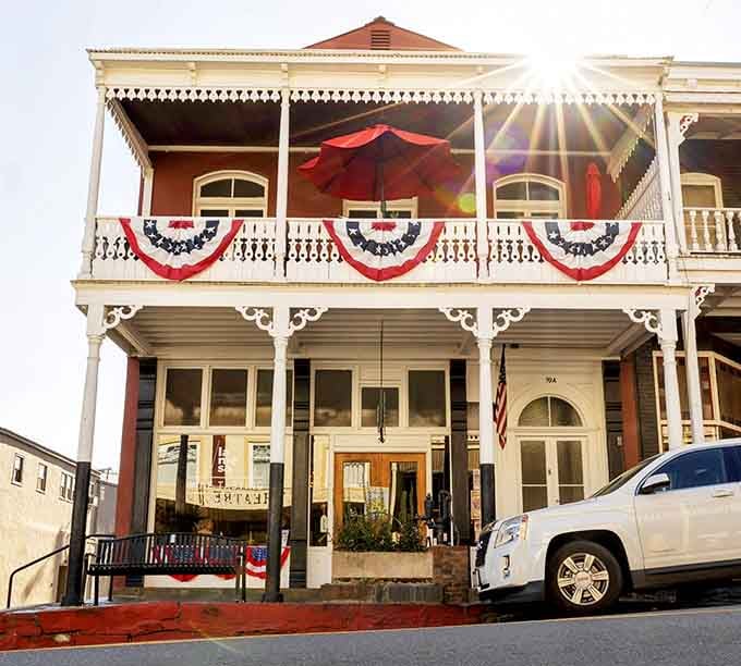 Patriotic bunting adorns this Victorian beauty like it's perpetually ready for a Fourth of July parade.