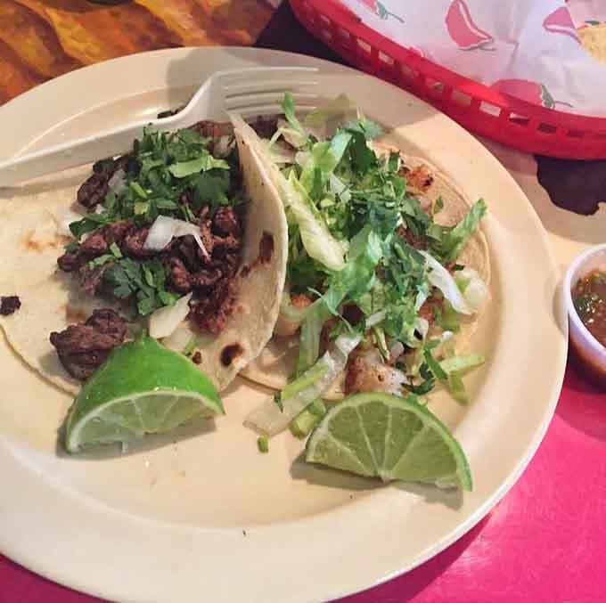 Tacos topped with fresh cilantro, onions, and lime wedges that look almost too beautiful to eat. Almost.